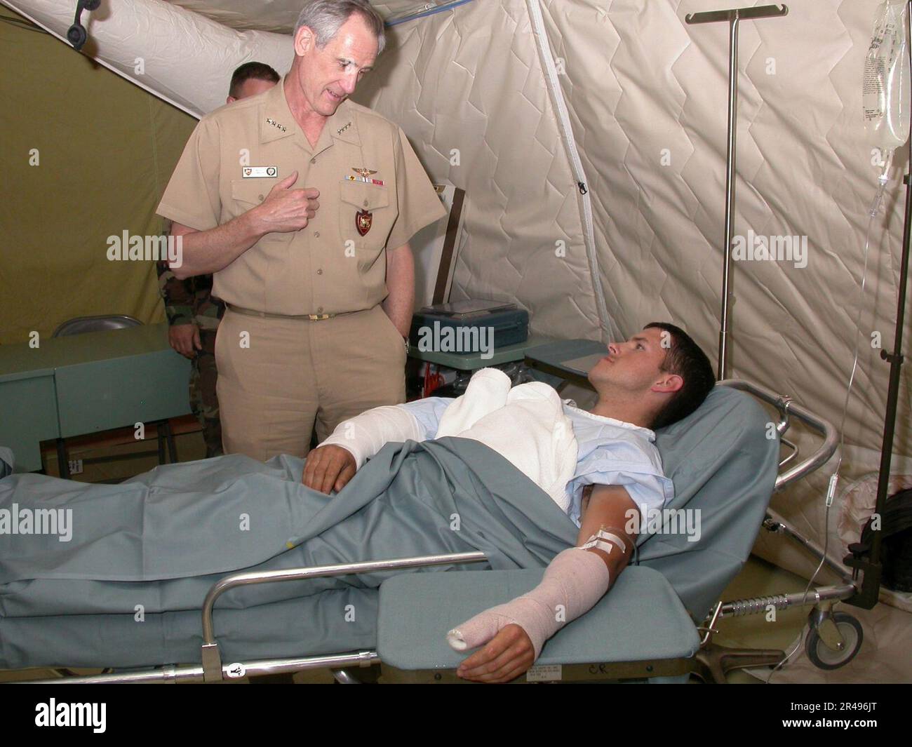 US Navy Adm. Gregory Johnson, Commander, U.S. Naval Forces Europe, visits with a wounded U.S ...