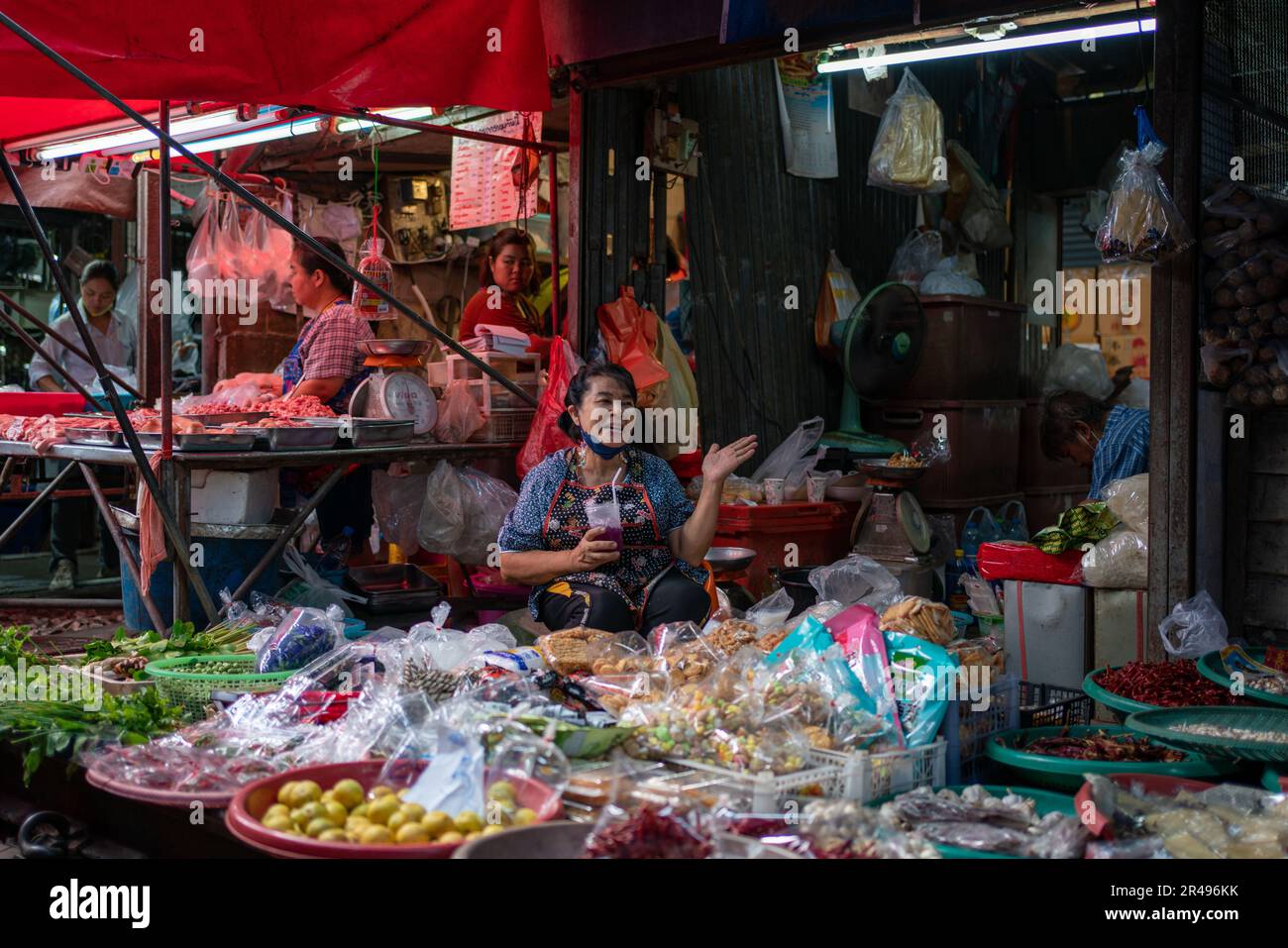 A scene of vendors manning stalls and chit-chatting in the local market ...