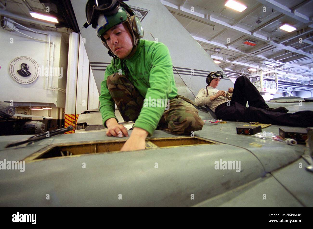 US Navy Aviation Structural Mechanic 1st Class performs maintenance on ...