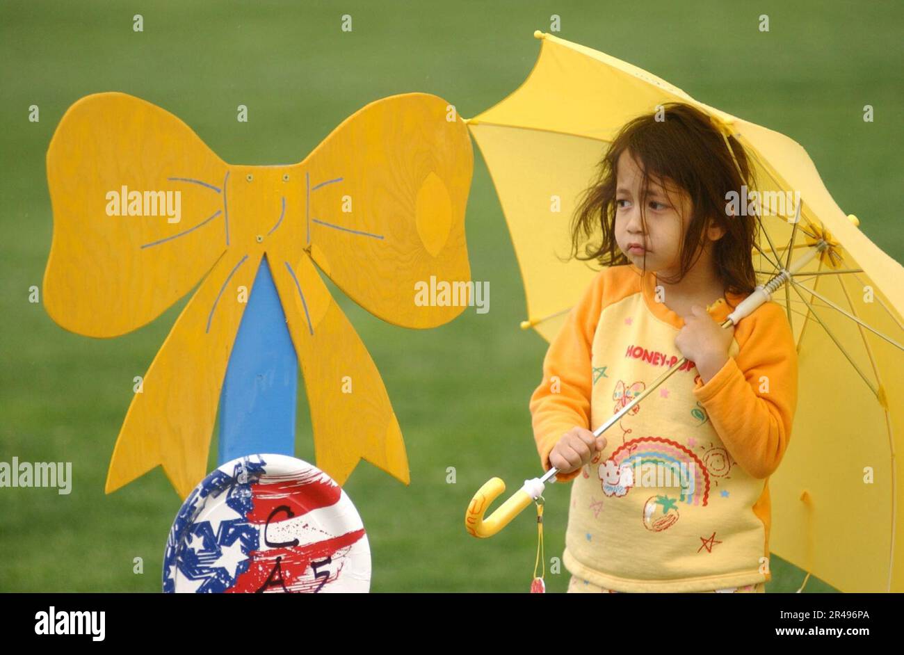 US Navy A little girl tries not to get too wet during Yellow Ribbon Day ...