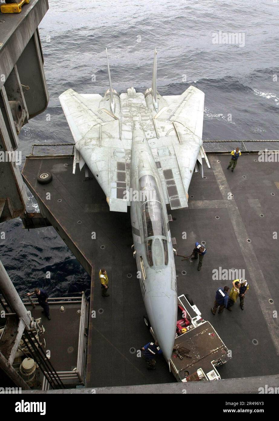 US Navy Hanger Deck Crew move a F-14D Tomcat onto one of four aircraft ...