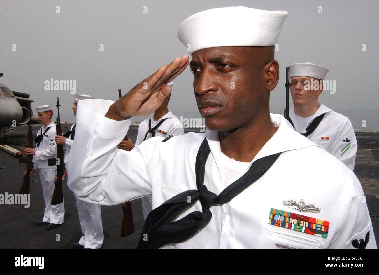 US Navy Torpedoman's Mate 1st Class salutes the color guard Stock Photo ...