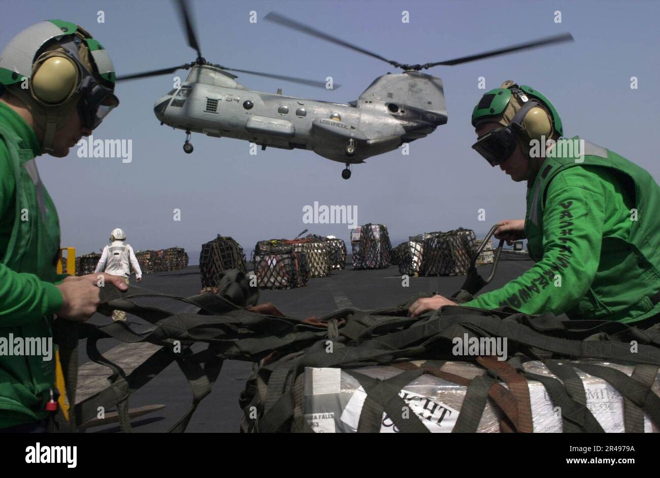 US Navy Crewmembers aboard USS Nimitz (CVN 68) unload nearly 300 pallets of supplies on the ...