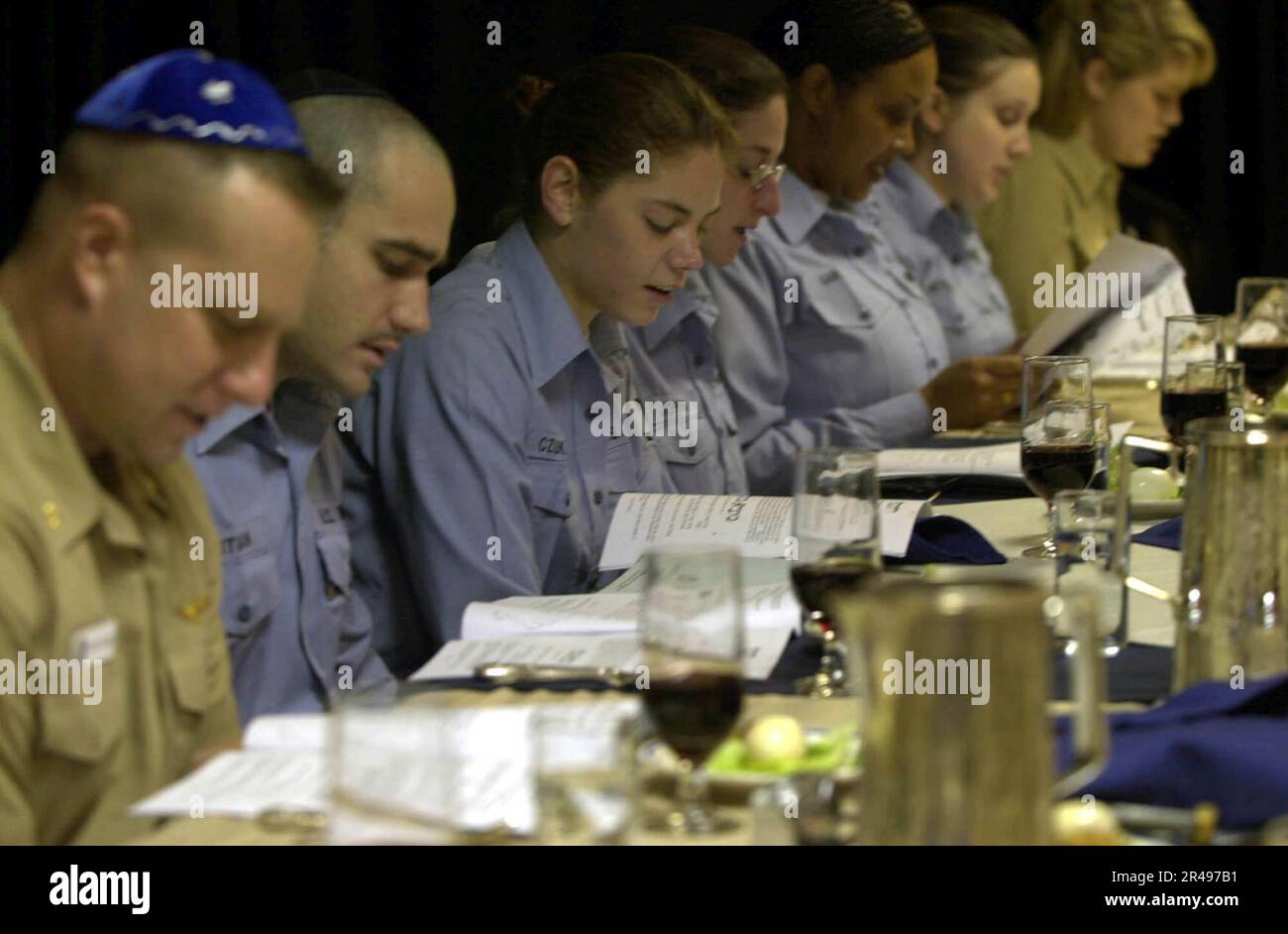 US Navy Crewmembers read from the Passover Hagaddah (prayer book ...