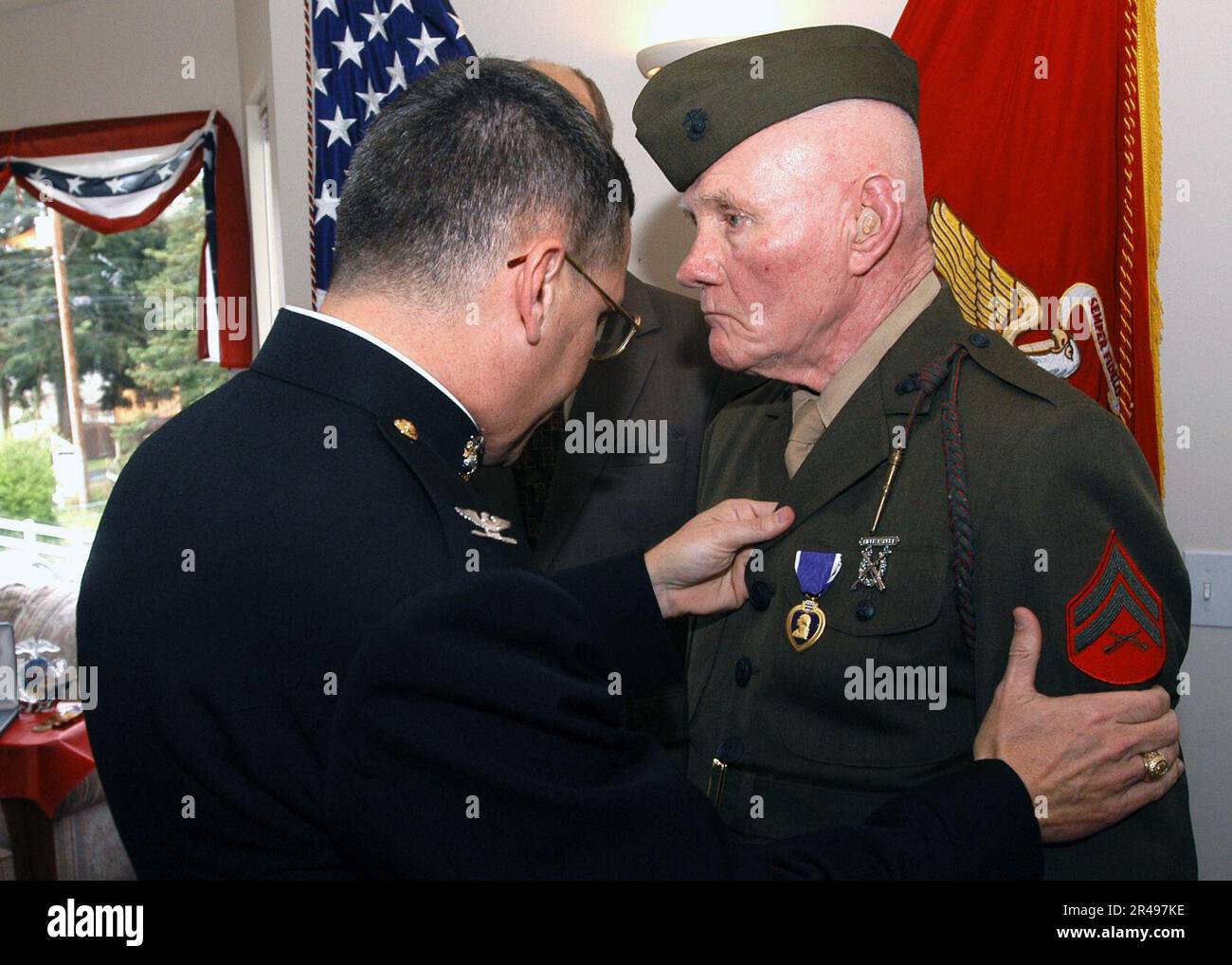 US Navy Col. Steven M. Keim pins a Purple Heart Award on the chest of ...