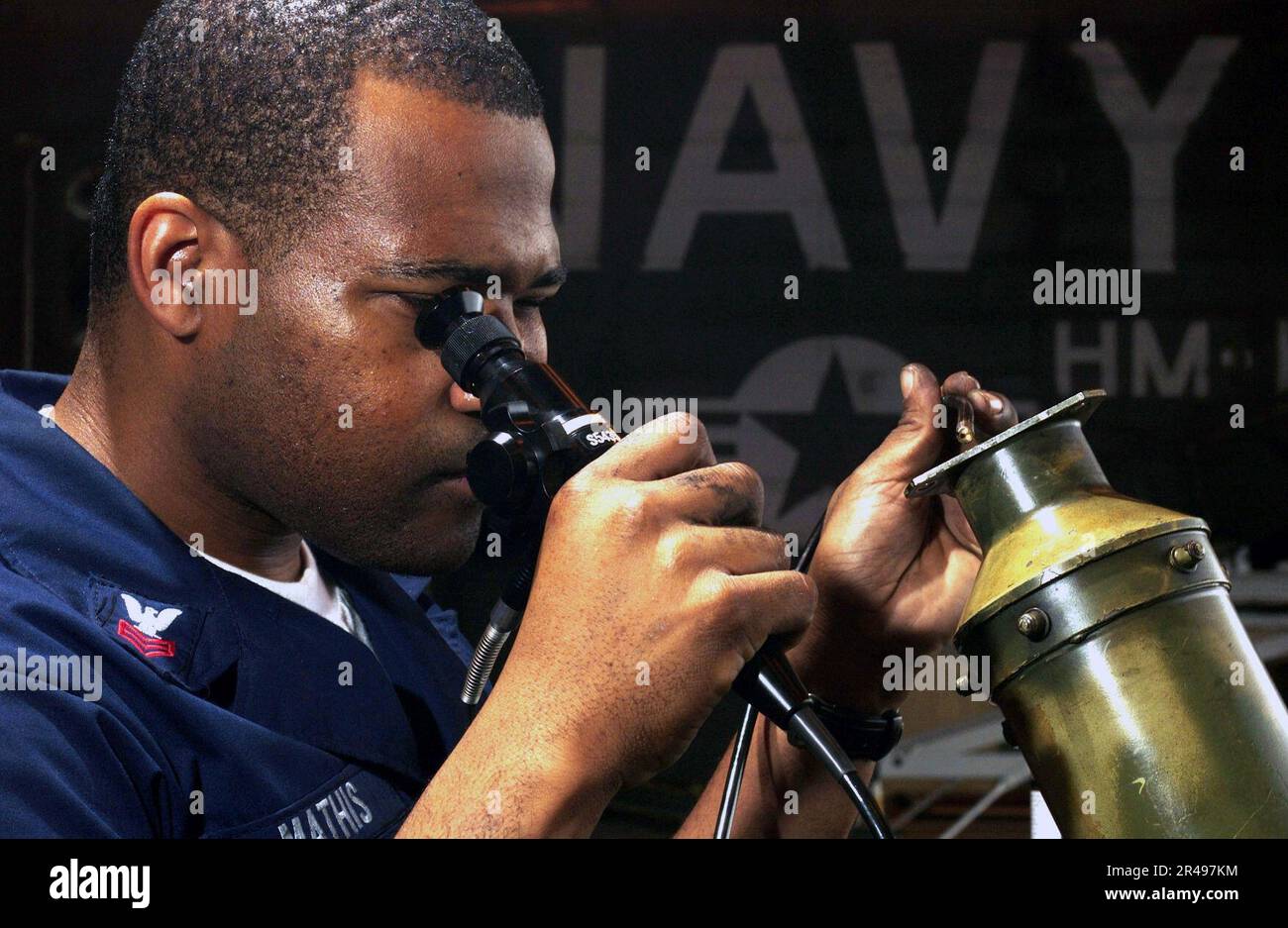 US Navy Aviation Machinist's Mate 1st Class uses a bore scope fiber ...