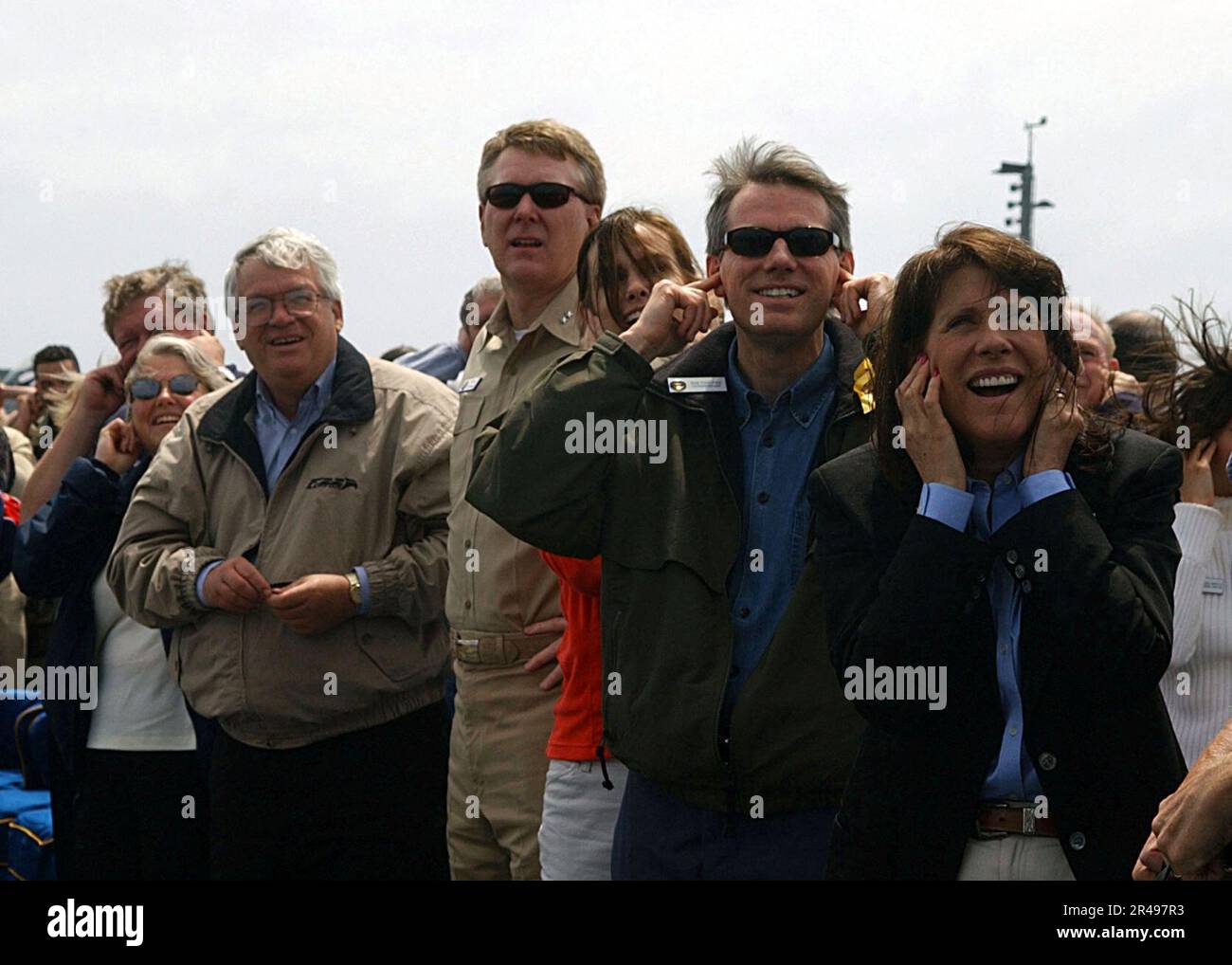 US Navy Sailors and Marines gather on the flight deck aboard USS Harry ...