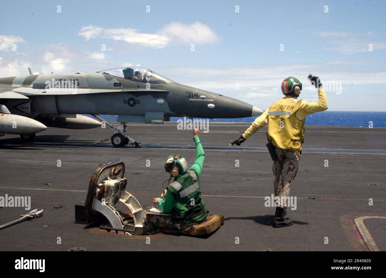 US Navy The center-deck hatch operator signals to the Stock Photo - Alamy