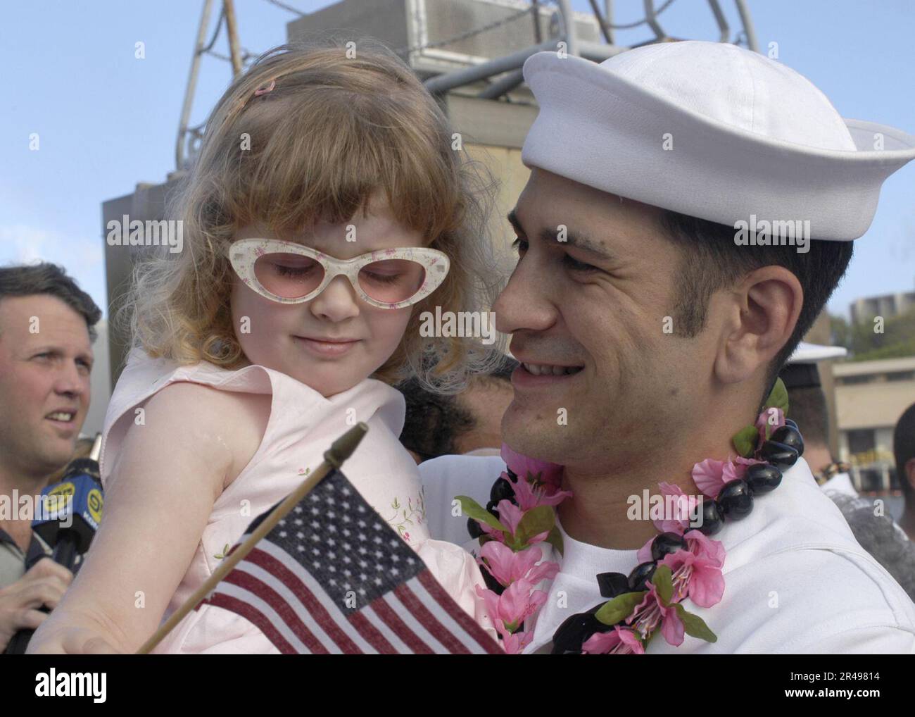 US Navy A sailor greets his daughter after debarking from the Los ...
