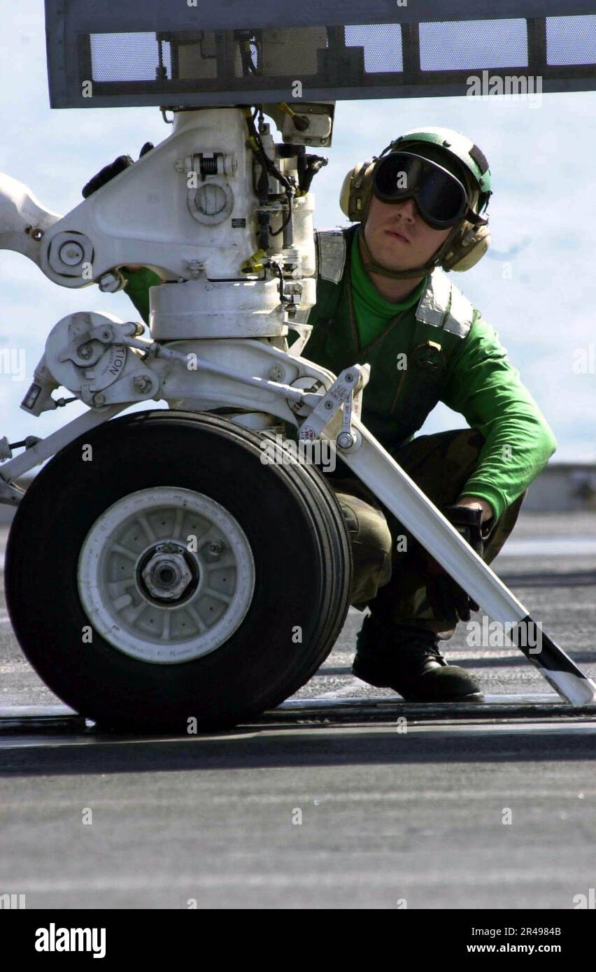 US Navy A crewmember inspects the launch bar before giving the thumbs ...