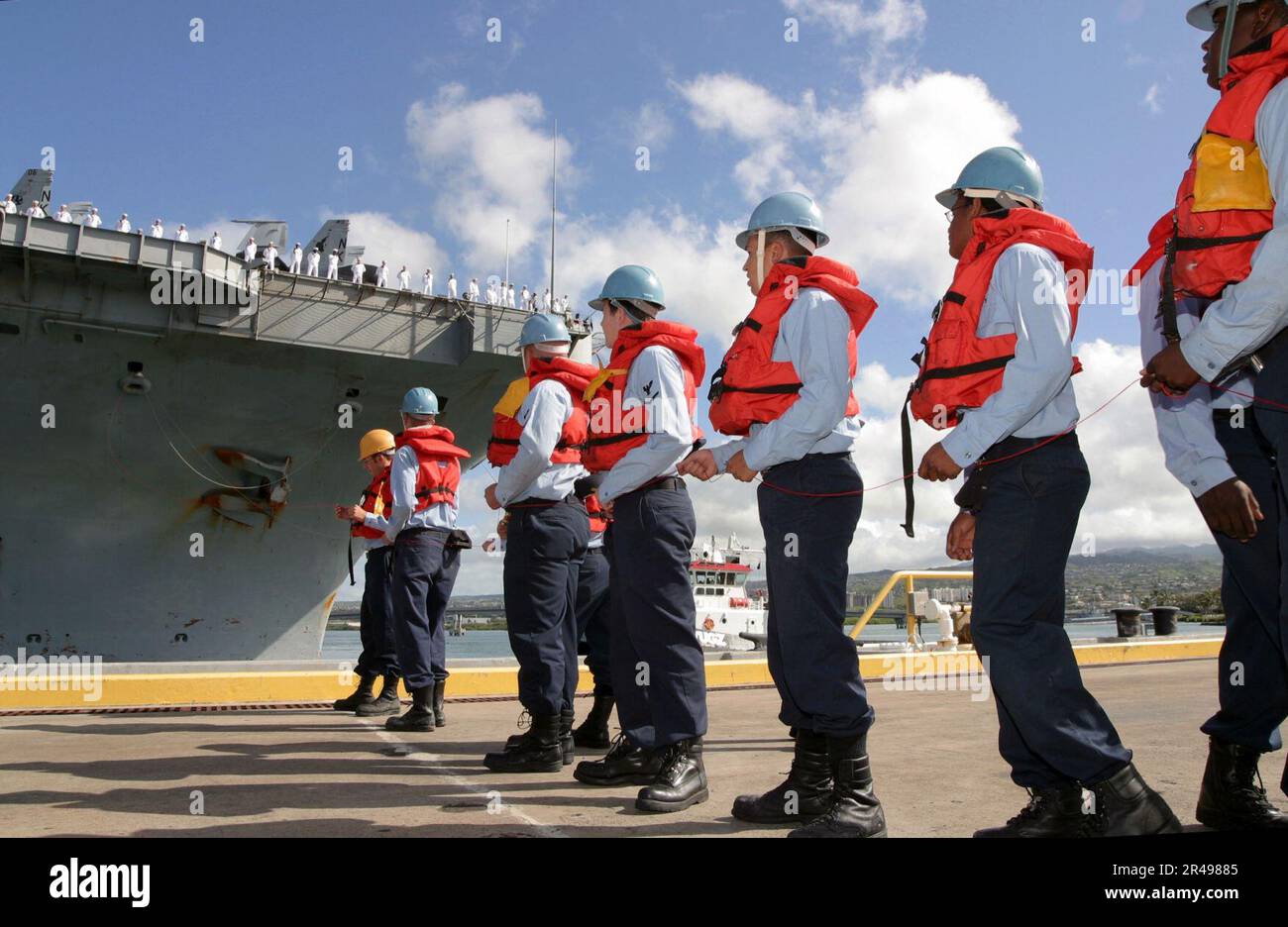 US Navy Naval Station Pearl Harbor line-handlers help moor the aircraft ...