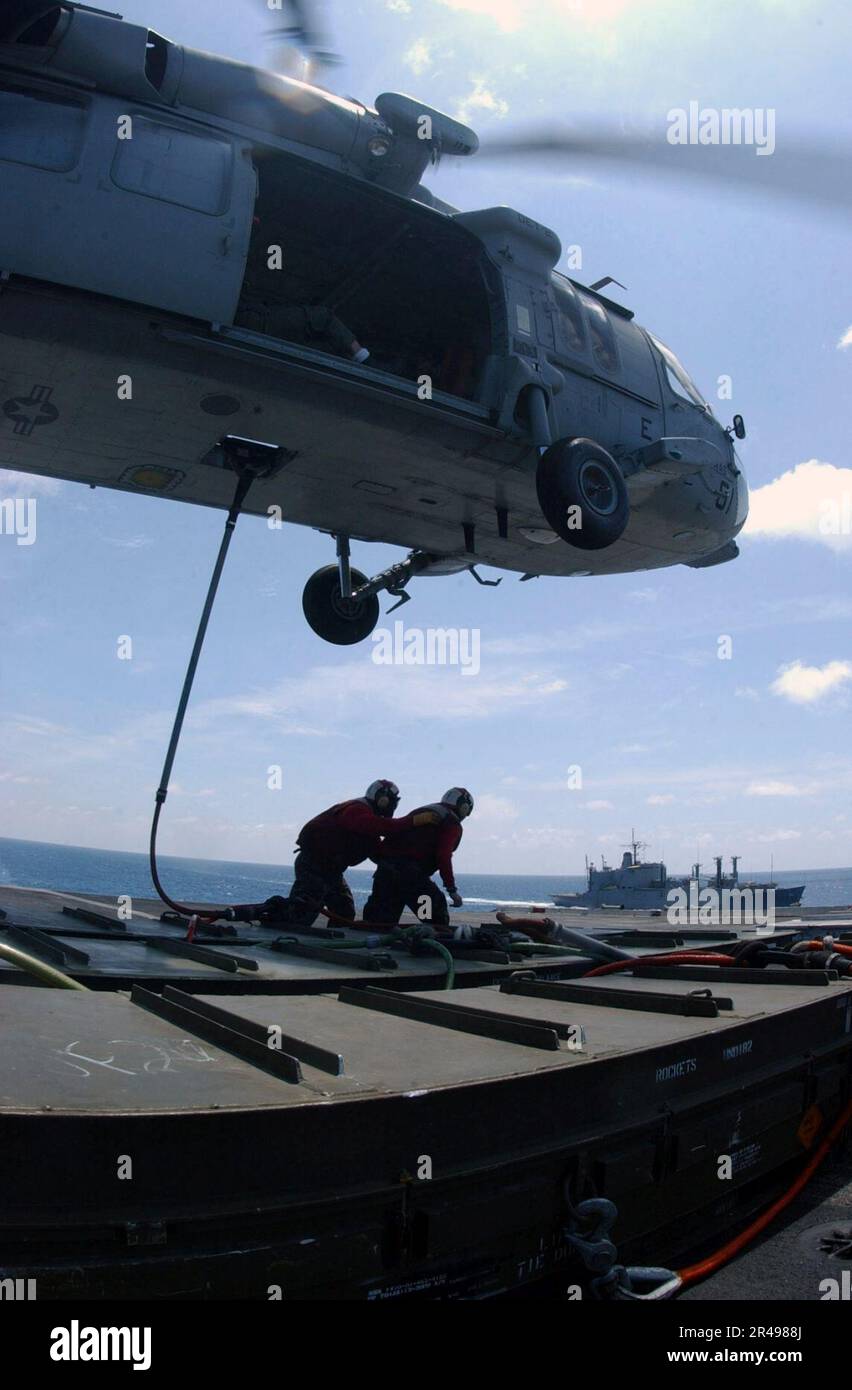 US Navy An SH-60 Seahawk hovers above flight deck aboard USS Kitty Hawk ...