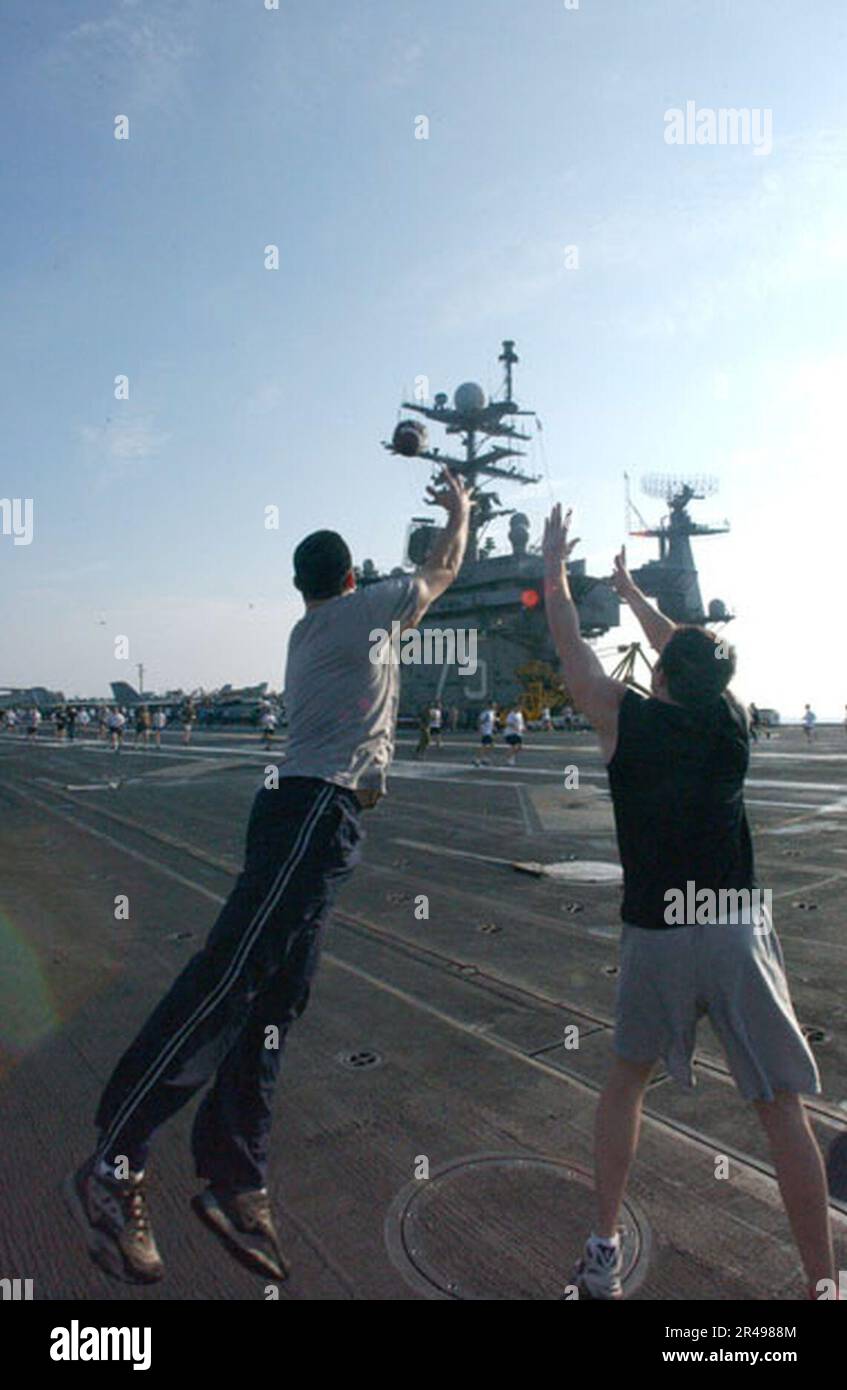 US Navy Sailors relax by playing football on the flight deck during a ...