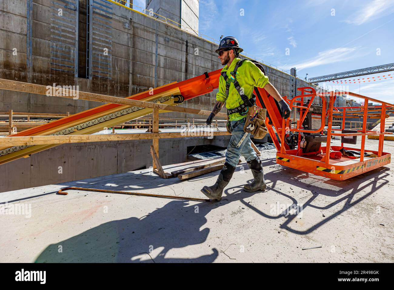 Construction laborers perform work on the chamber floor concrete infill ...
