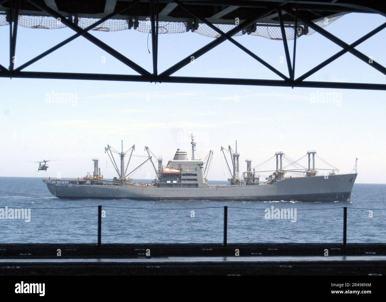 US Navy A CH-46 Sea Knight helicopter picks up a pallet of ammunition ...