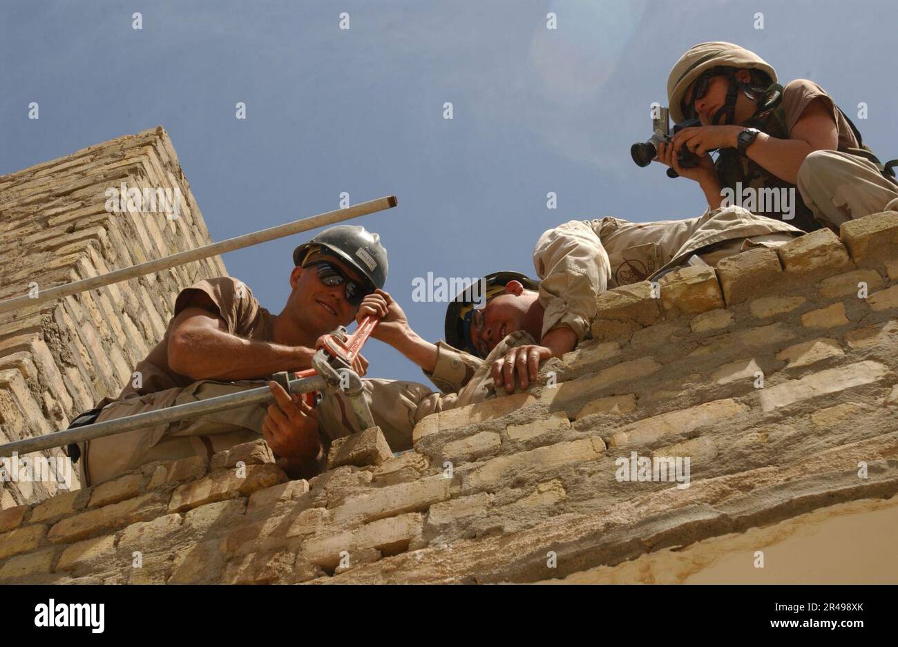 US Navy NMCB-7 repair plumbing to a water collection tank during a ...