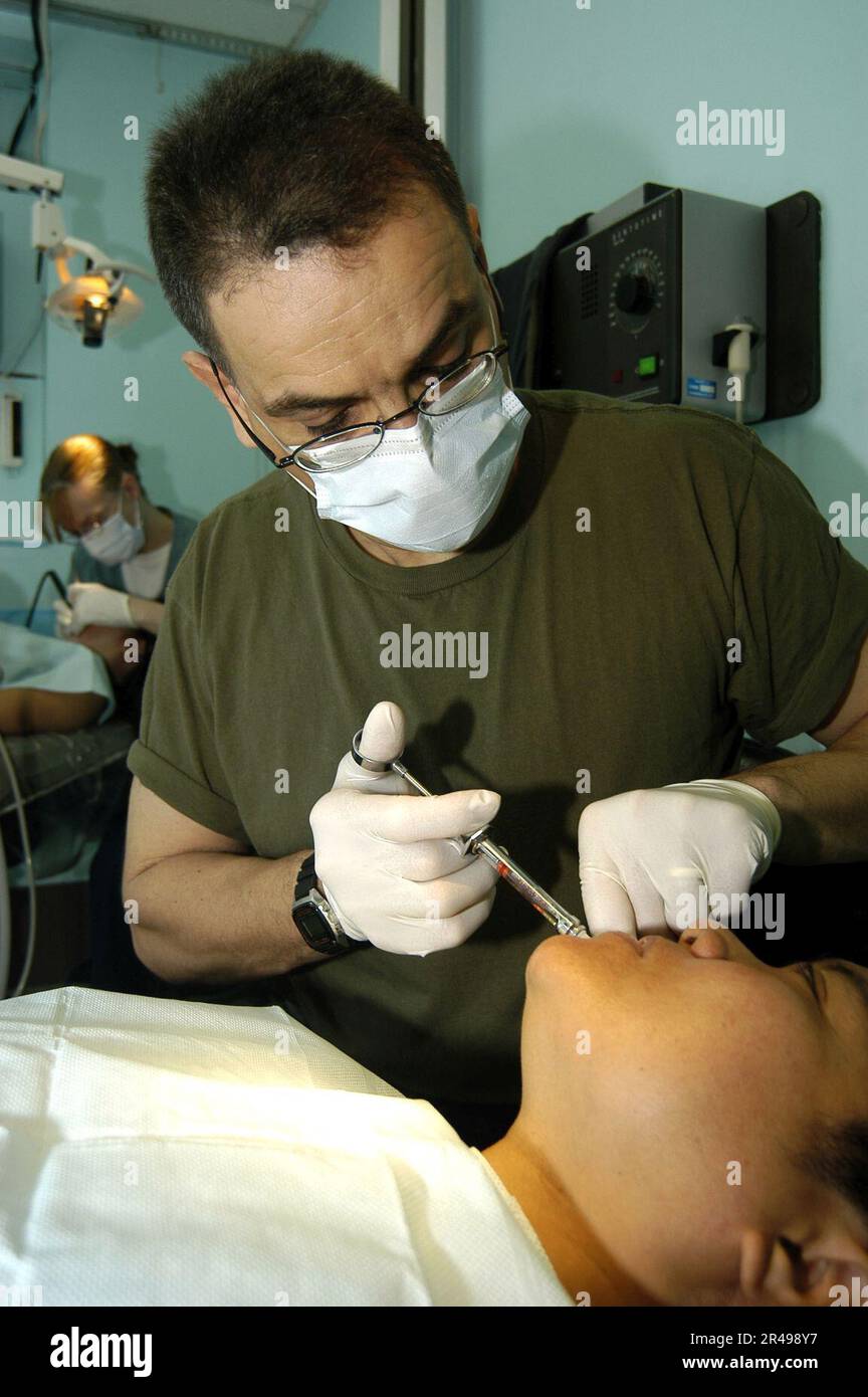 US Navy Cmdr. Jerry Torres, a dentist attached to the 31st Marine ...