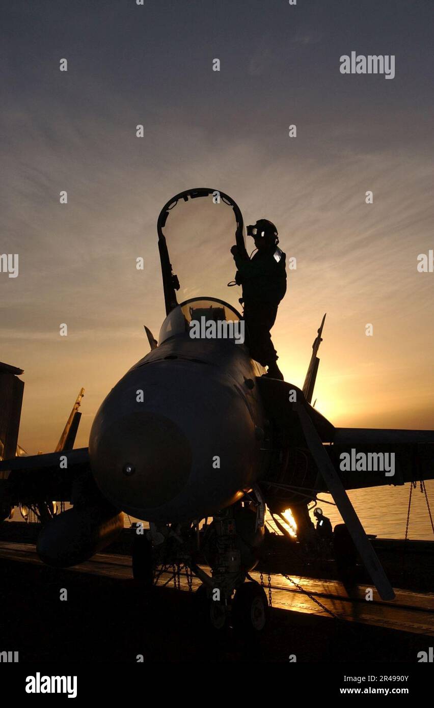 US Navy A Sailor climbs into the cockpit of an F-A-18 Hornet before ...