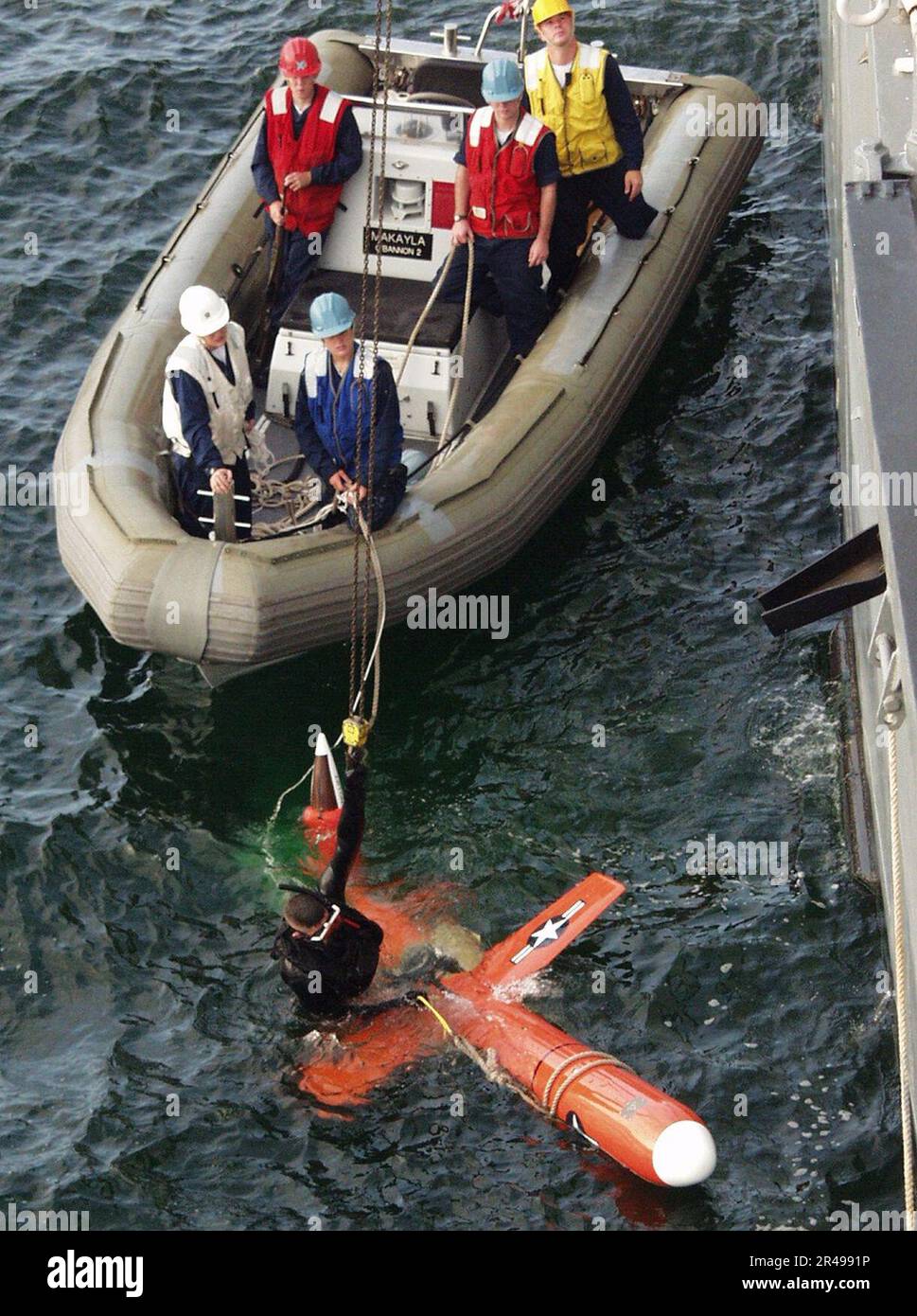 US Navy USS O'Bannon (DD 987) boat crew assists a rescue swimmer in ...