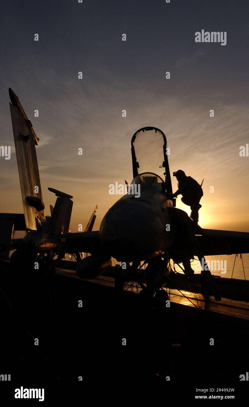 US Navy A Sailor climbs into the cockpit of an F-A-18 Hornet strike ...