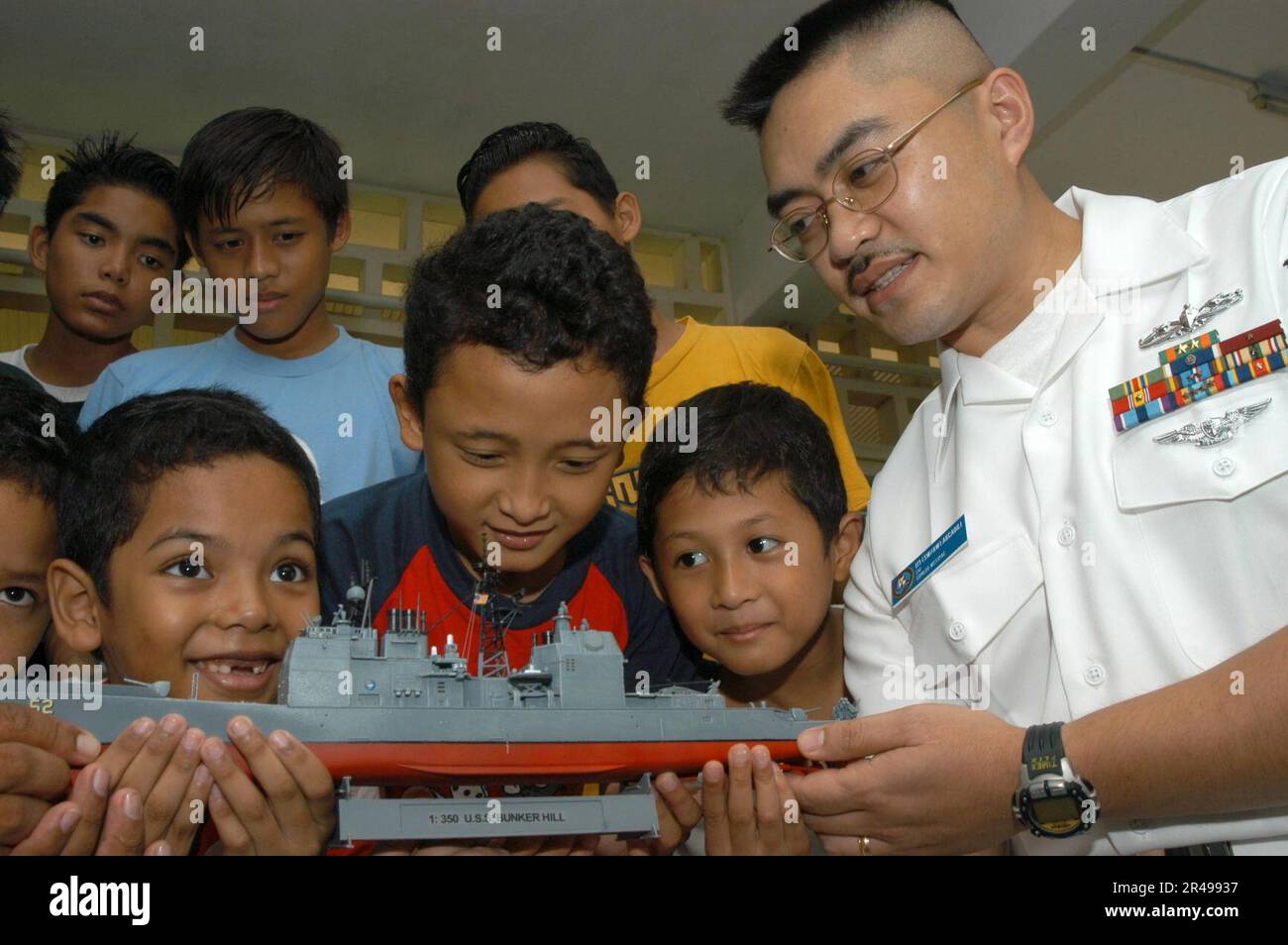US Navy Information Systems Technician 1st Class shows residents of the Jamiyah Children's Home ...