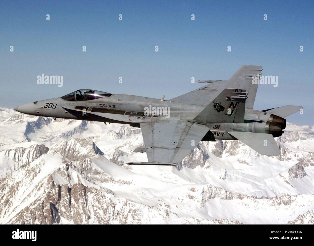 US Navy An F-A-18C Hornet flies over the Sierra Nevada Mountains during ...