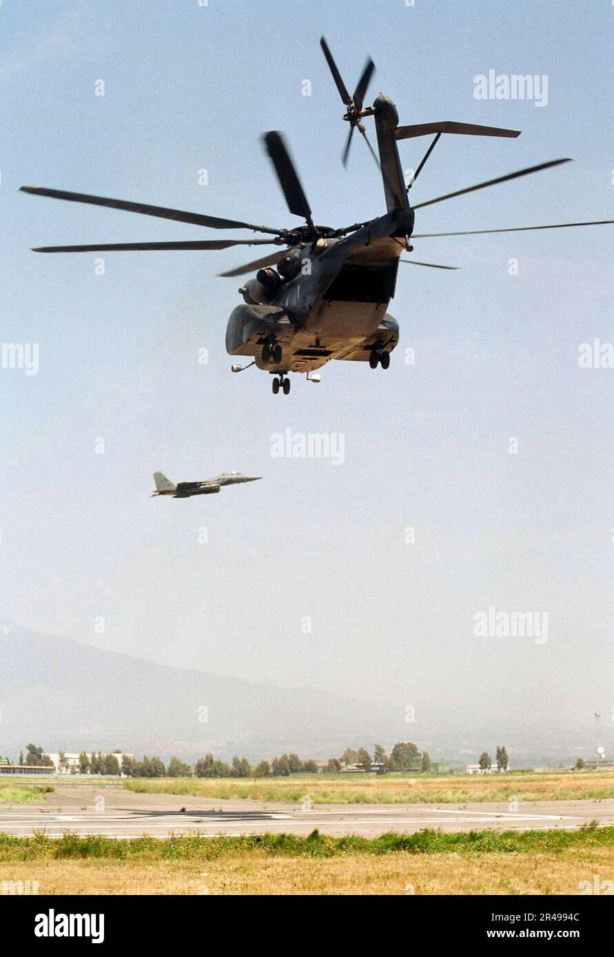 US Navy An Air Force F-15E Strike Eagle takes off as an MH-53E Sea ...