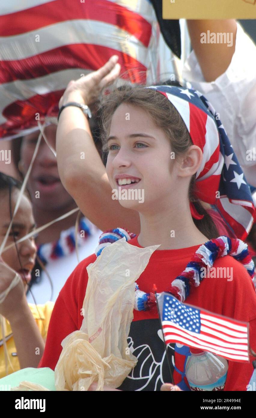 US Navy A young girl, proudly wears the colors of the United States and ...