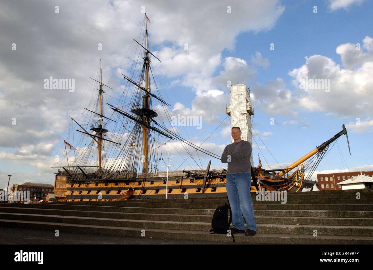 US Navy Photographer's Mate 1st Class poses for a photo in front of the ...