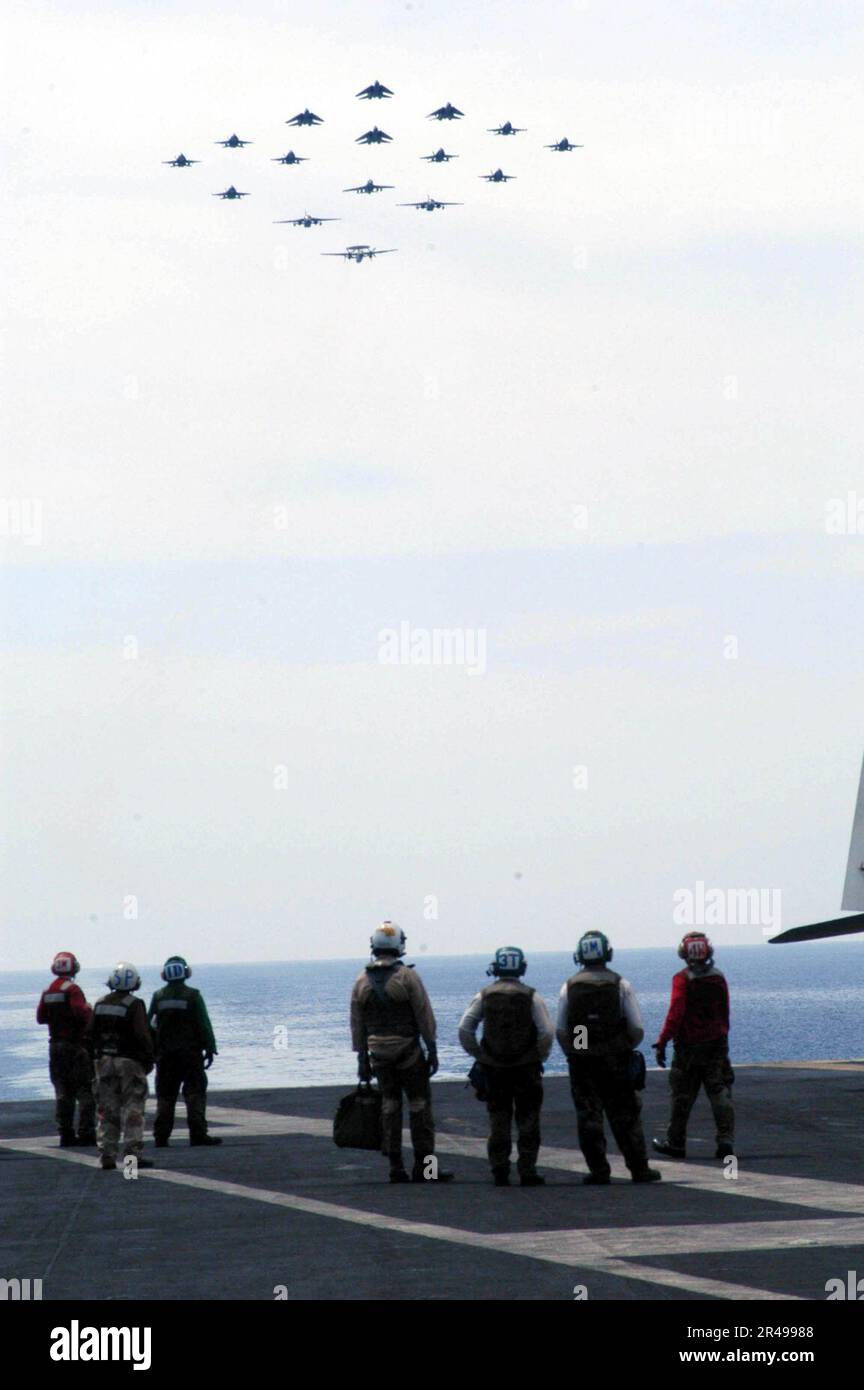 US Navy Crewmembers aboard USS Theodore Roosevelt (CVN 71) watch from the flight deck as Carrier ...