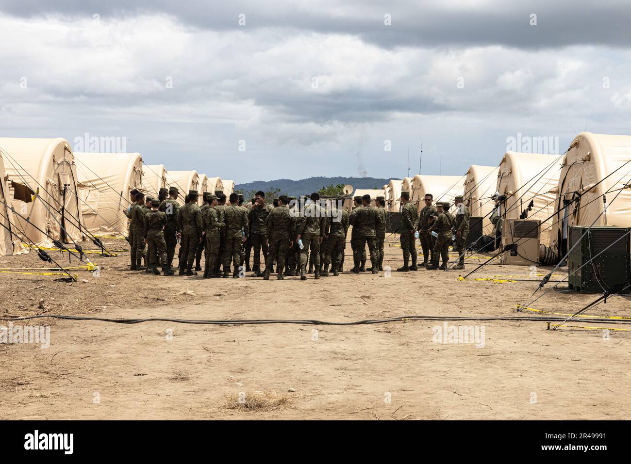 Philippine Army cadets walk past berthing tents during a tour of Camp ...