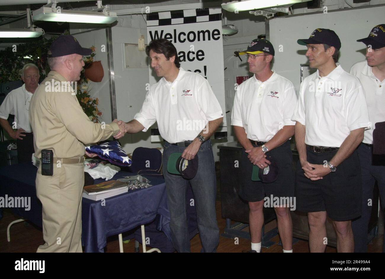 US Navy Ron Fellows receives an American flag from the acting Command ...