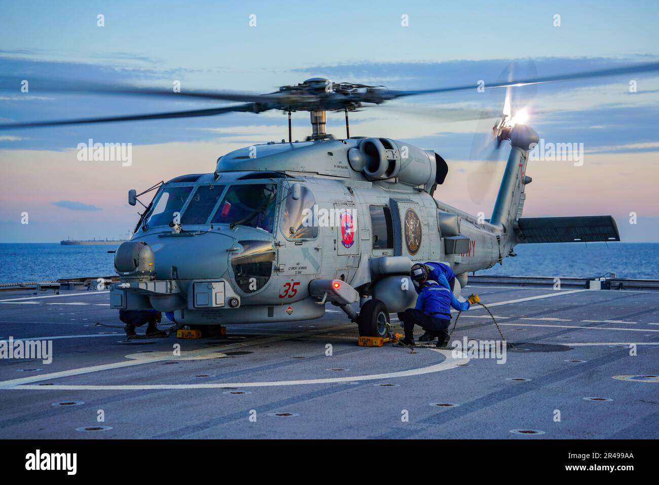 NATUNA SEA (Mar. 26, 2023) Sailors use chocks and chains to secure an ...