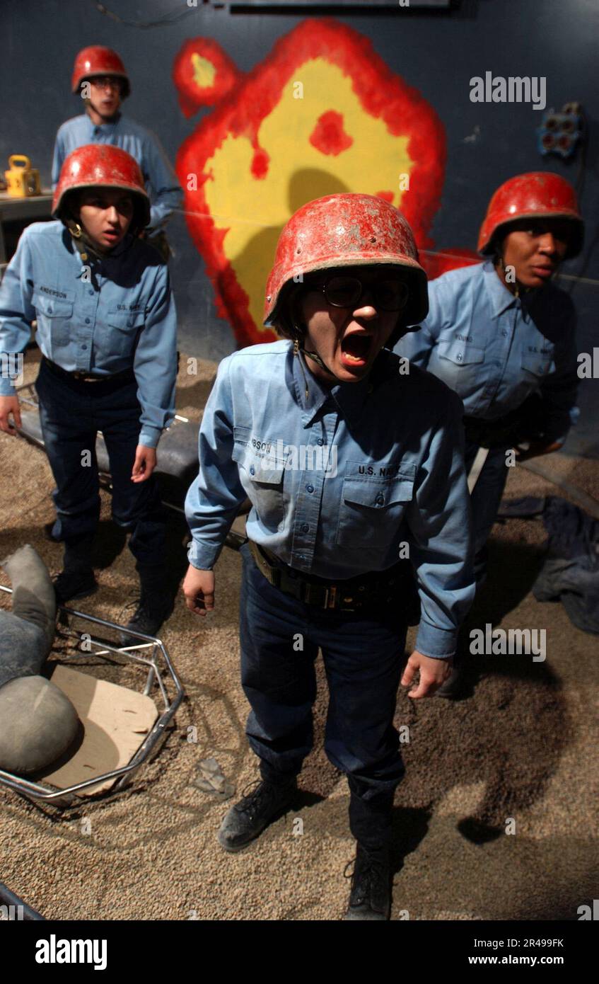 US Navy A recruit shouts orders to her teammates, to move a Stokes ...