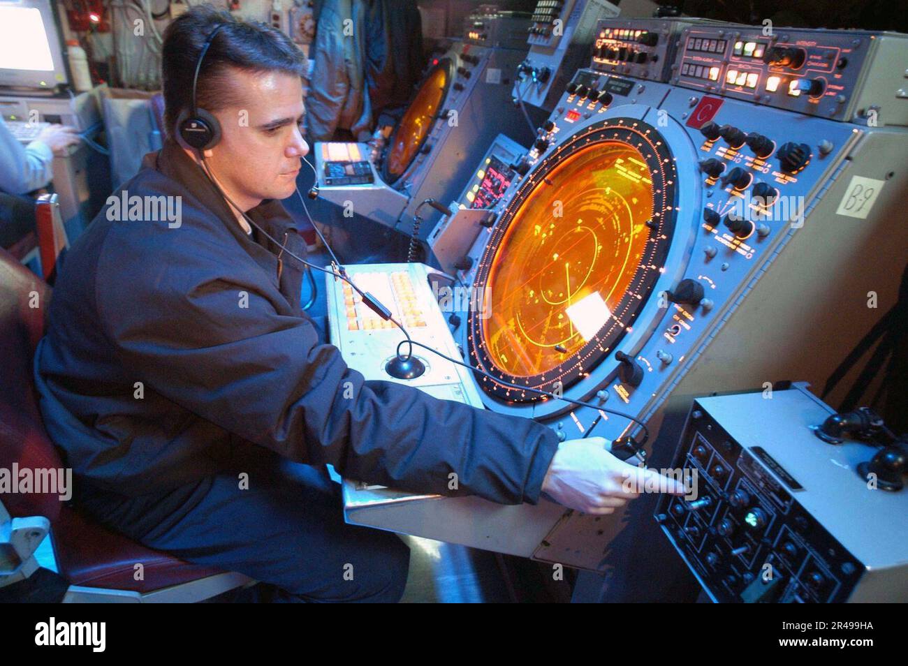 US Navy Air Traffic Controller 1st Class stands watch in the helo ...