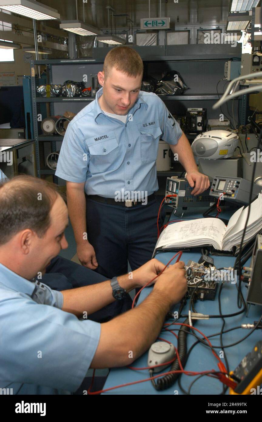 US Navy Sailors troubleshoot an Inter-Communications Set (ICS) jack box ...
