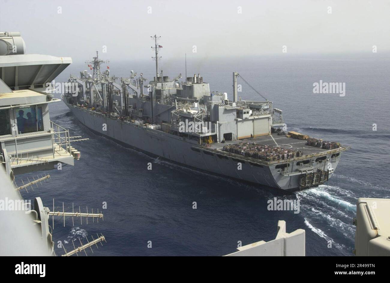 US Navy USS Nimitz (CVN 68) approaches USS Bridge (AOE 10) to begin an ...