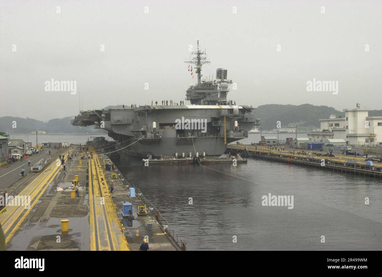 US Navy USS Kitty Hawk (CV 63) is moved into dry dock at Fleet ...