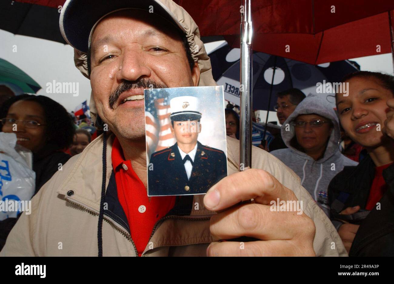 US Navy Families and friends wait in the rain on the pier at Naval ...