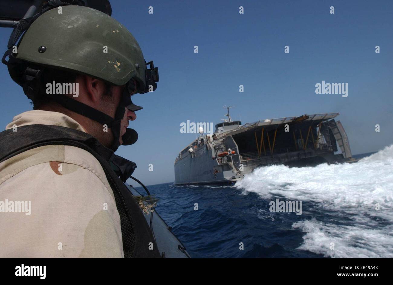 US Navy Special Boat Team member acts as a safety observer behind Joint ...
