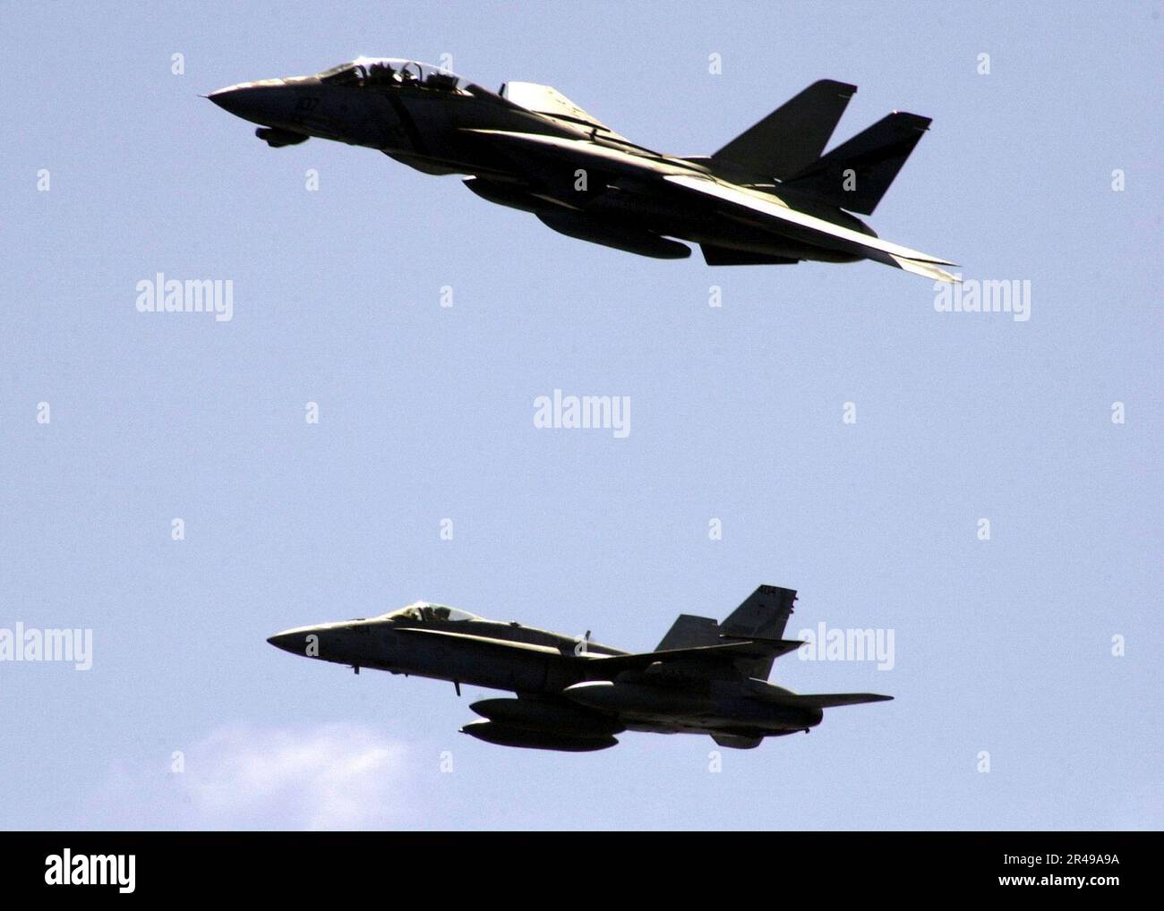 US Navy An F-14D Tomcat and an F-A-18C Hornet conduct a fly-by of ...