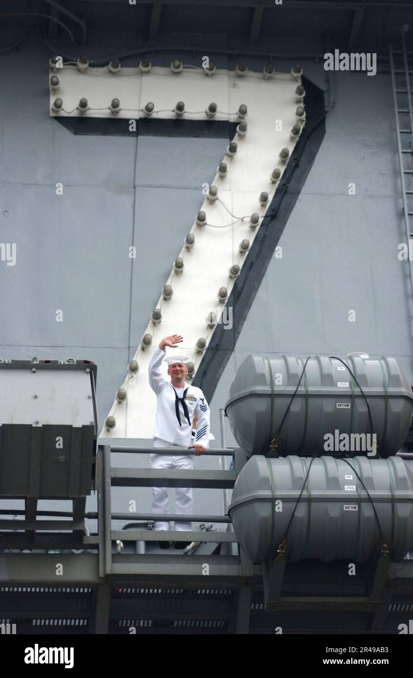 US Navy Hospital Corpsman 1st Class waves to his wife from the flight ...