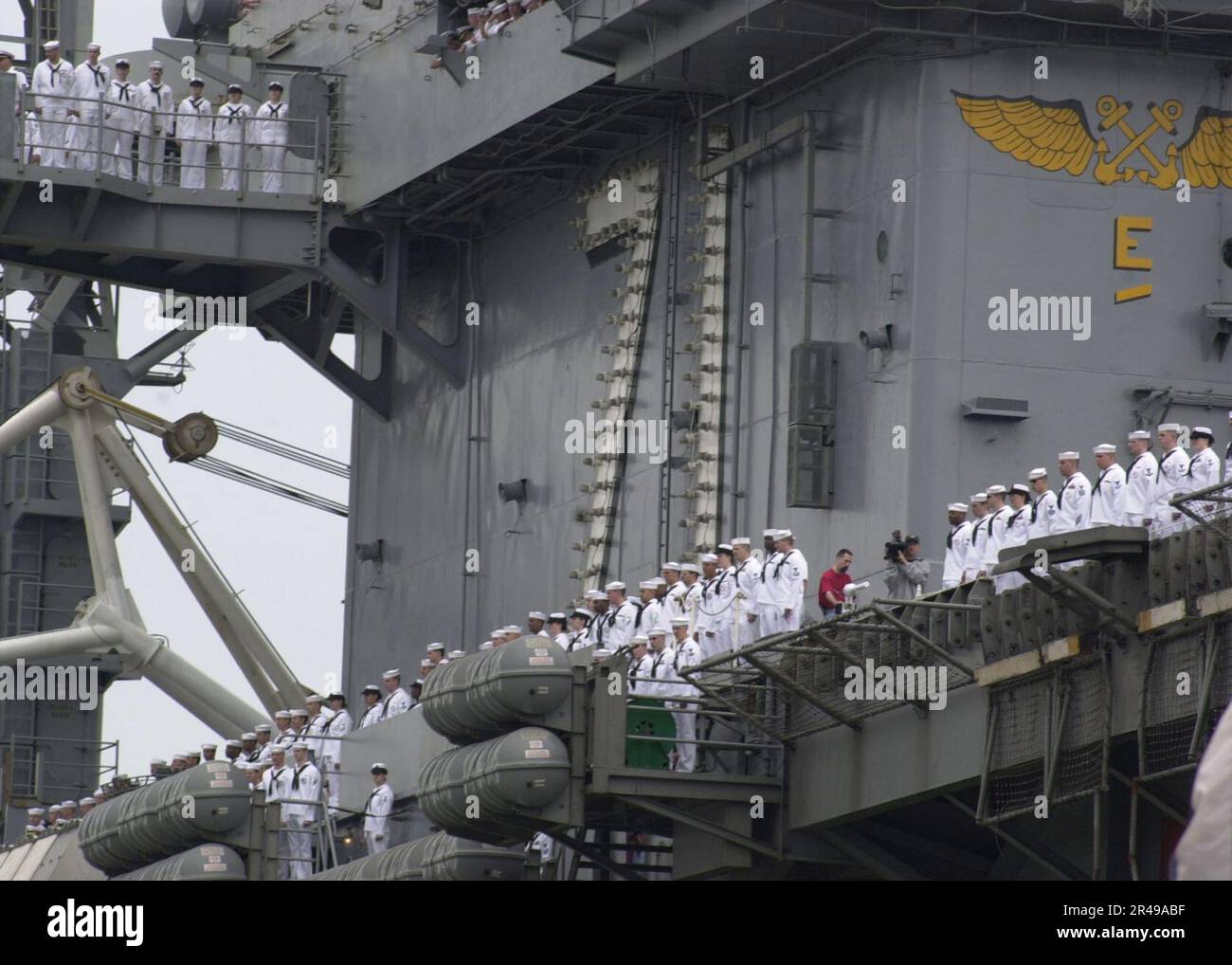 US Navy Sailors aboard the aircraft carrier USS Theodore Roosevelt (CVN 71) ''man the rails ...