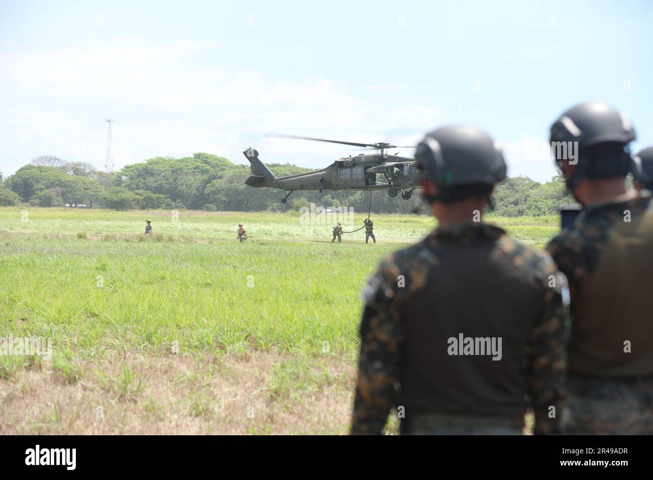 Guatemalan Naval Special Forces observe Navy SEALs fast rope from a ...
