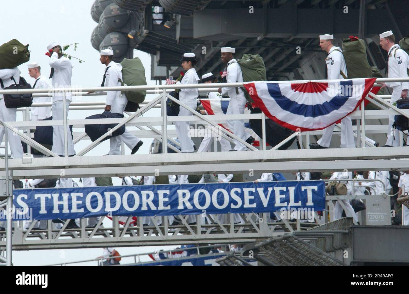 US Navy Sailors assigned to USS Theodore Roosevelt (CVN 71) depart the ...