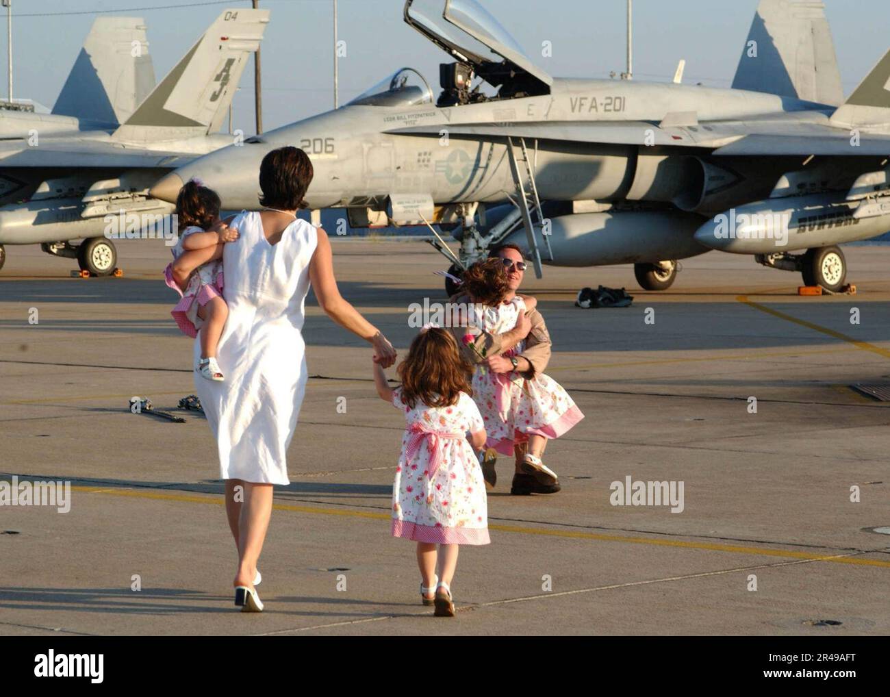 US Navy mdr. William Fitzpatrick embraces his family upon returning ...