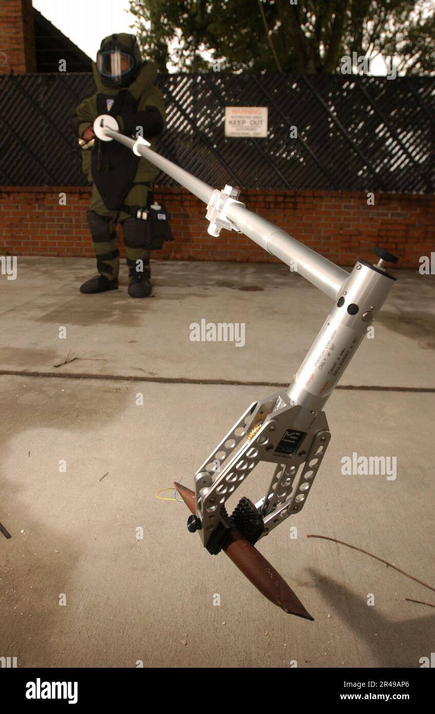 US Navy Aviation Ordnanceman 1st Class wearing a bomb suit, uses a ...