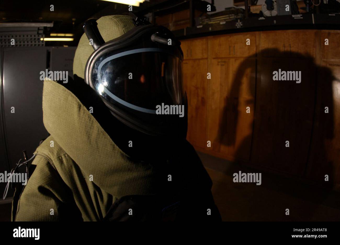 US Navy Aviation Ordnanceman 1st Class wears a heavy protective bomb ...