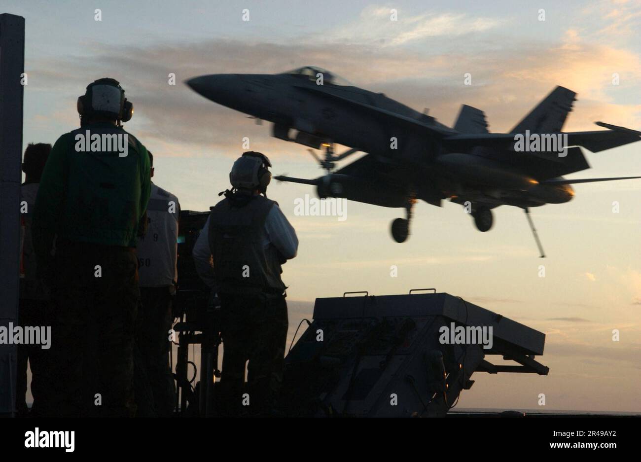 US Navy Landing Signal Officers (LSO) watch as an F-A-18C Hornet from ...