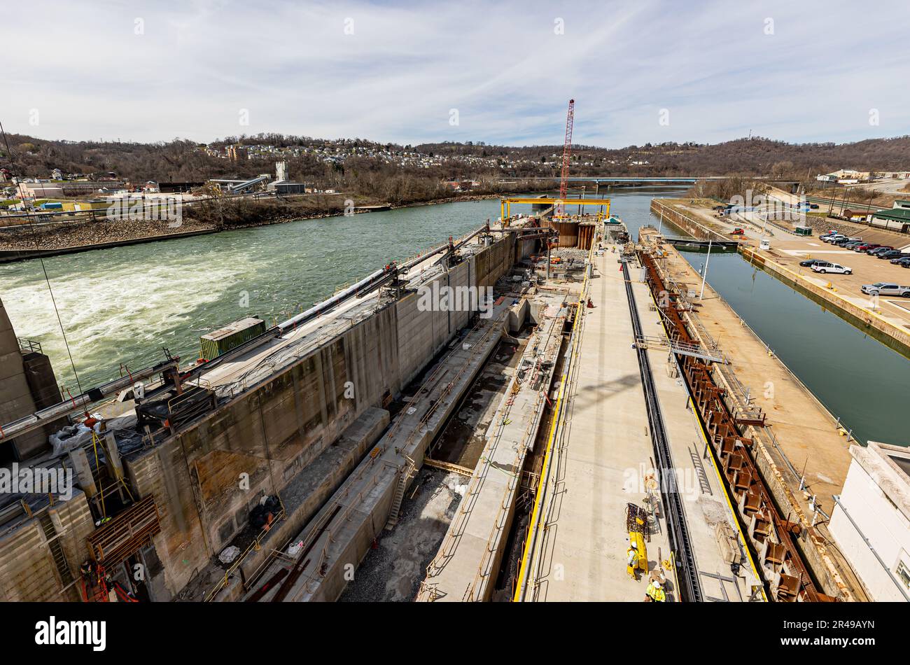 Construction laborers perform work on the chamber floor concrete infill ...